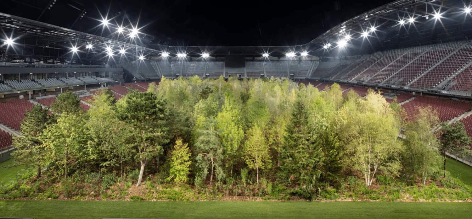 Artist turns Austrian football stadium into a forest - Springwise